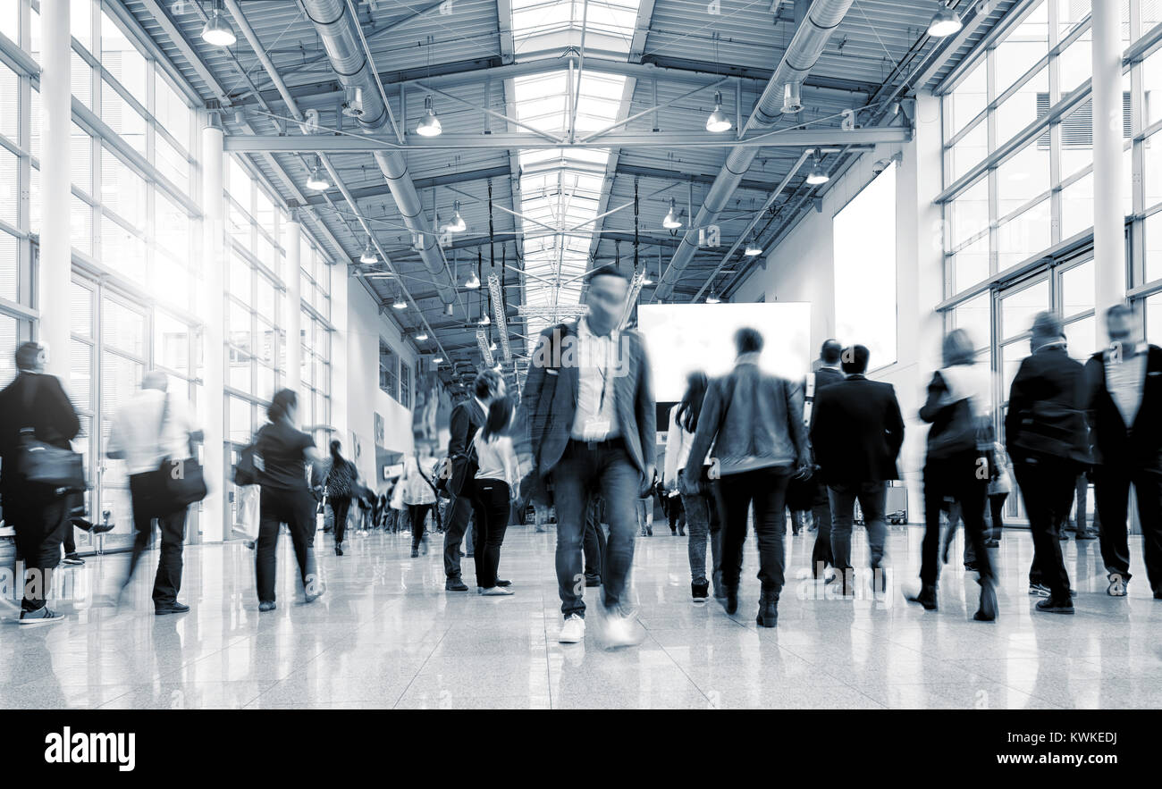 crowd of people rushing in a fair hall Stock Photo - Alamy