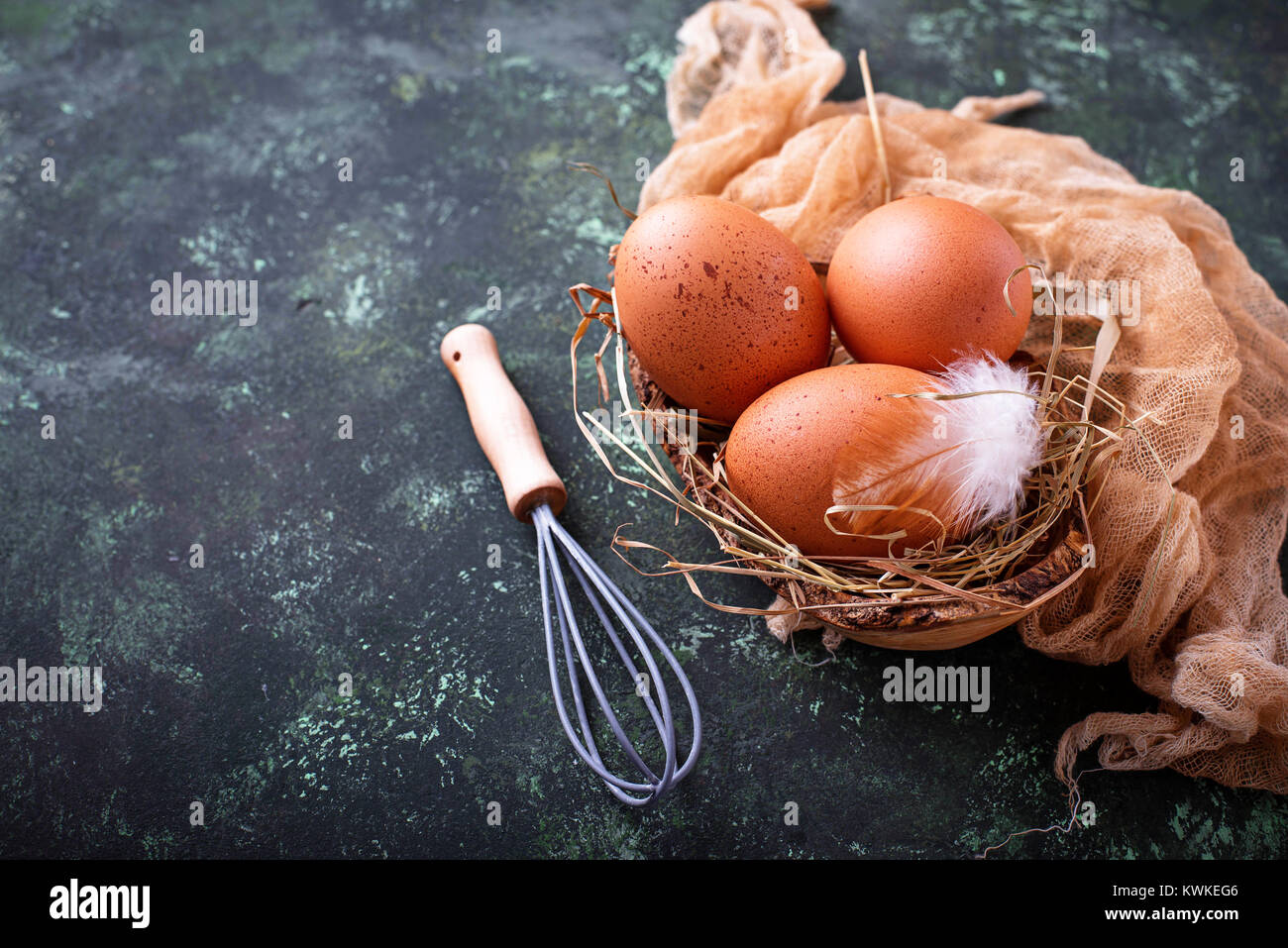 Raw chicken eggs and whisk Stock Photo - Alamy