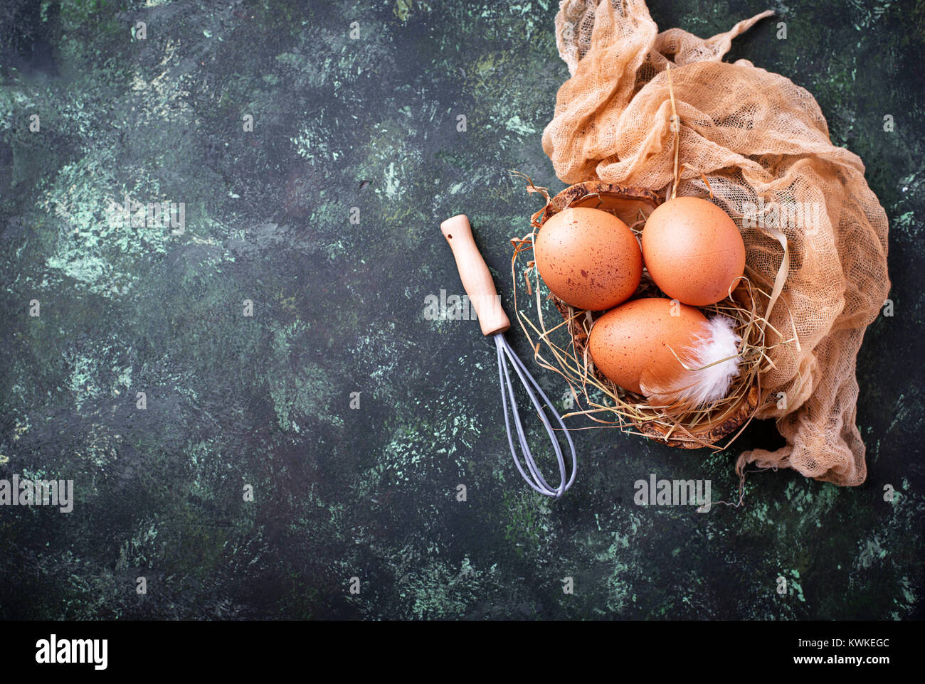 Raw chicken eggs and whisk Stock Photo - Alamy