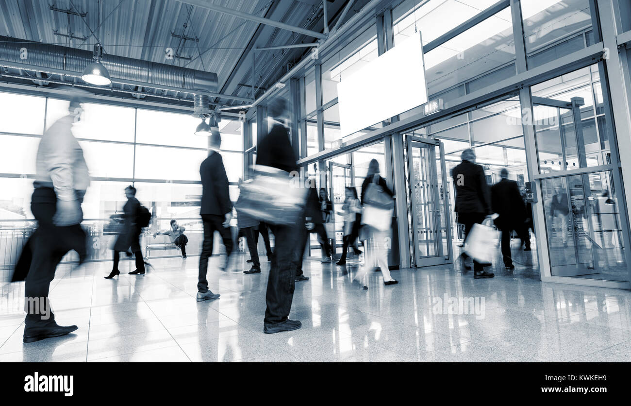 crowd of business people rushing in a entrance at a trade show ...