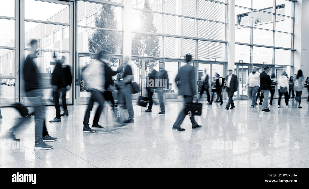 blurred crowd of business people rushing in modern floor of a business ...