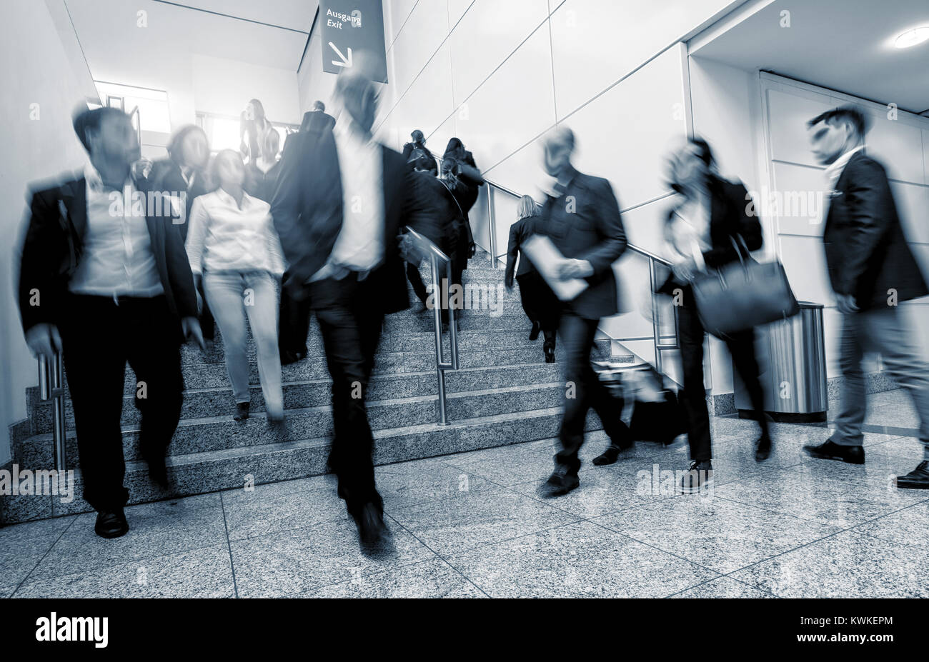 business people rushing on stairs in a modern hall Stock Photo - Alamy