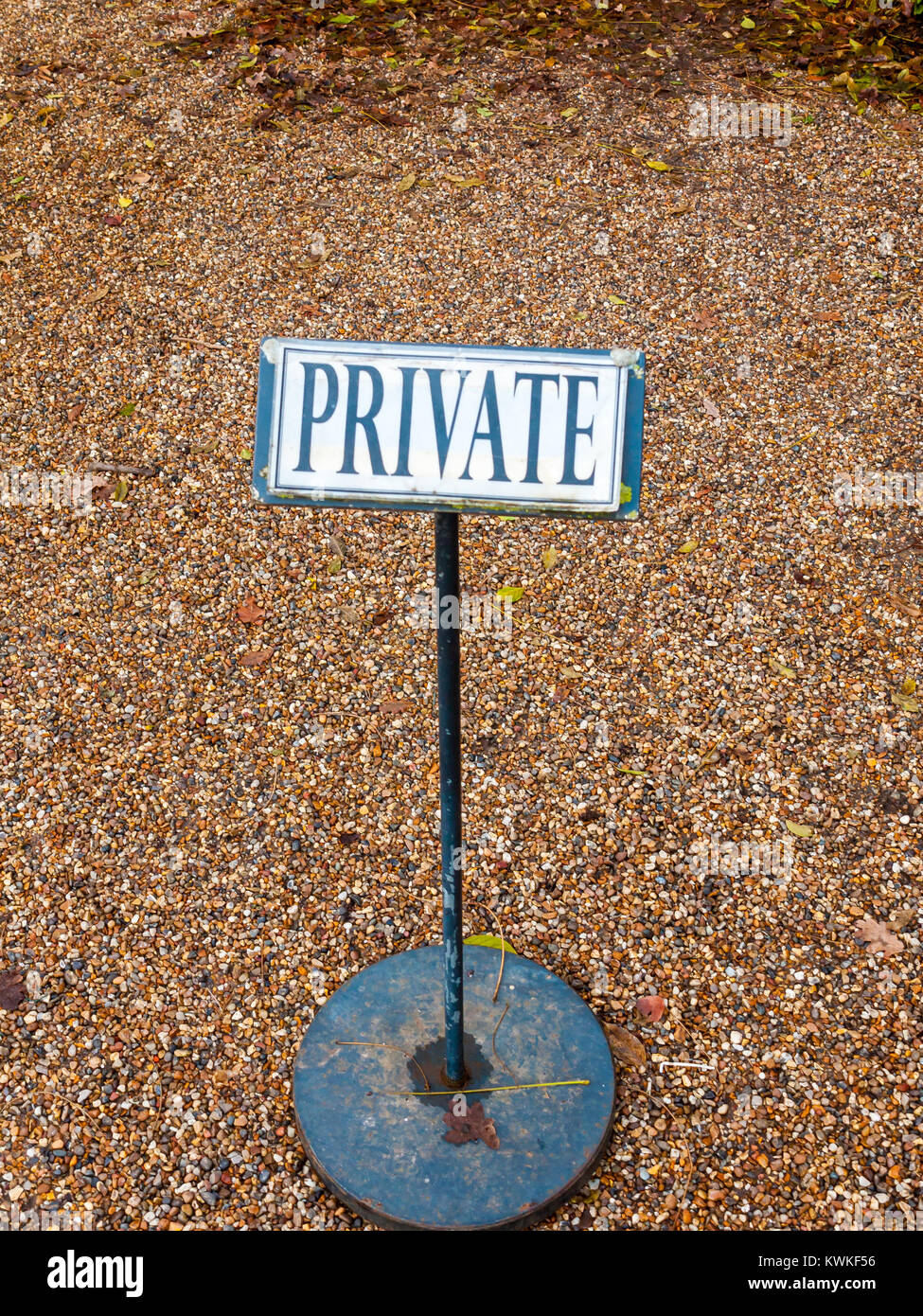 black and white private sign post metal cobble floor; essex; england ...
