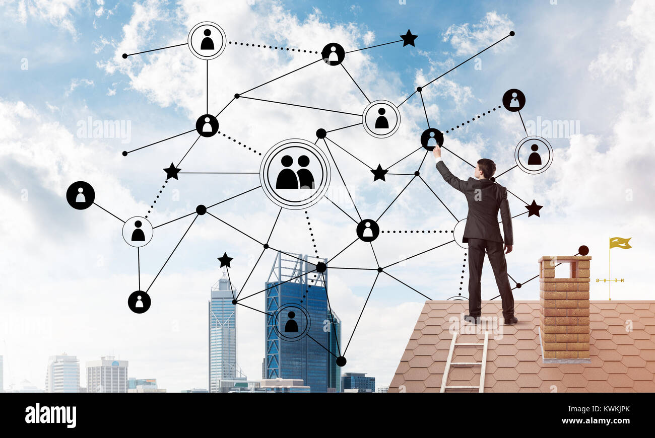 Businessman on house roof presenting networking and connection concept ...