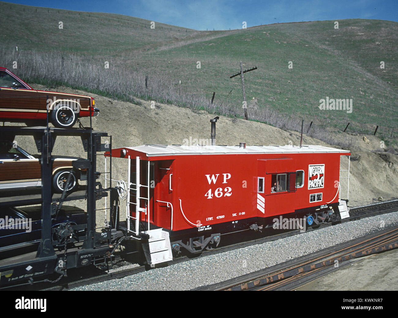 An image featuring a little red caboose behind a train, capturing the ...