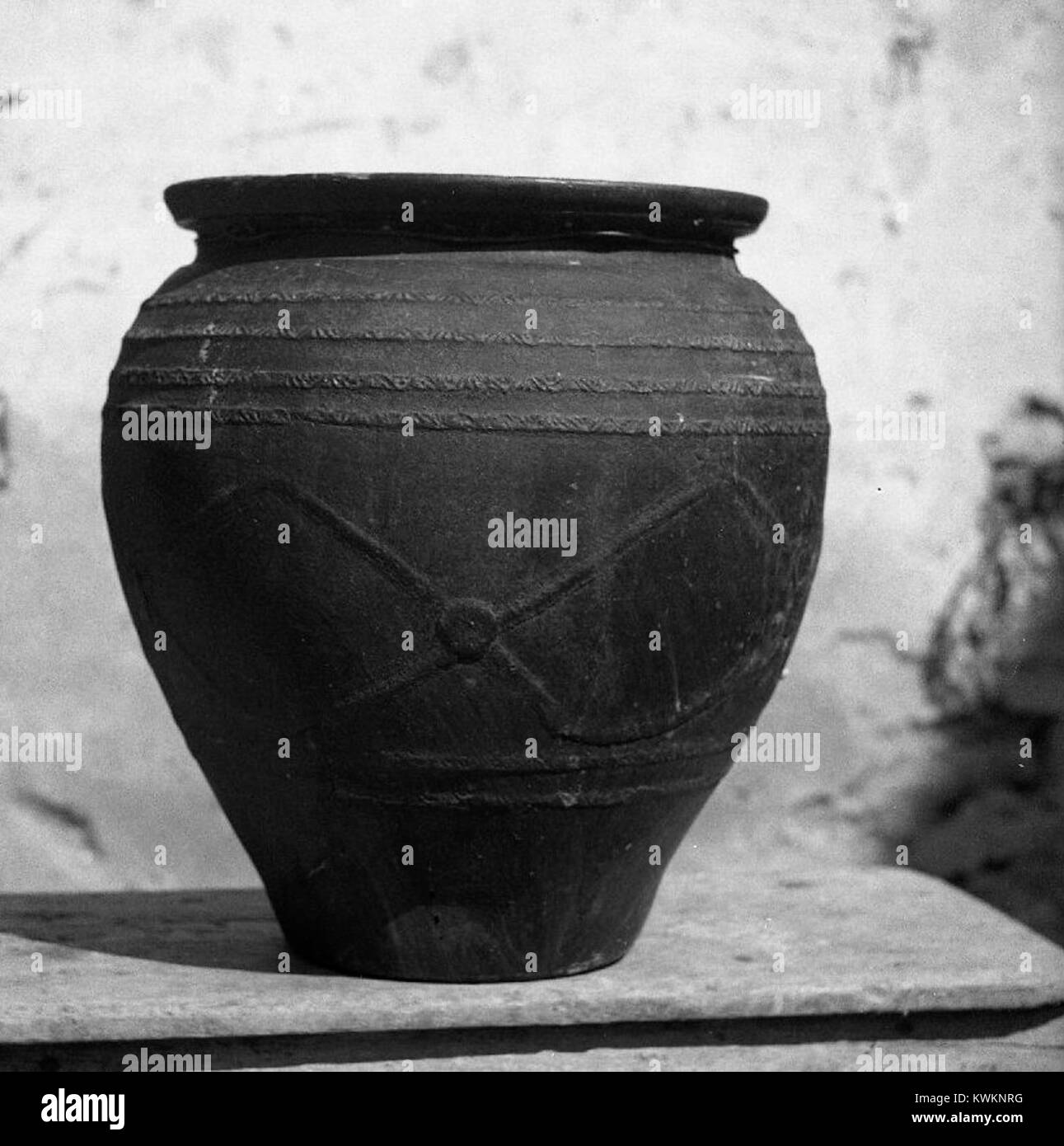A historical photograph from 1953 showing a traditional cooking pot ...