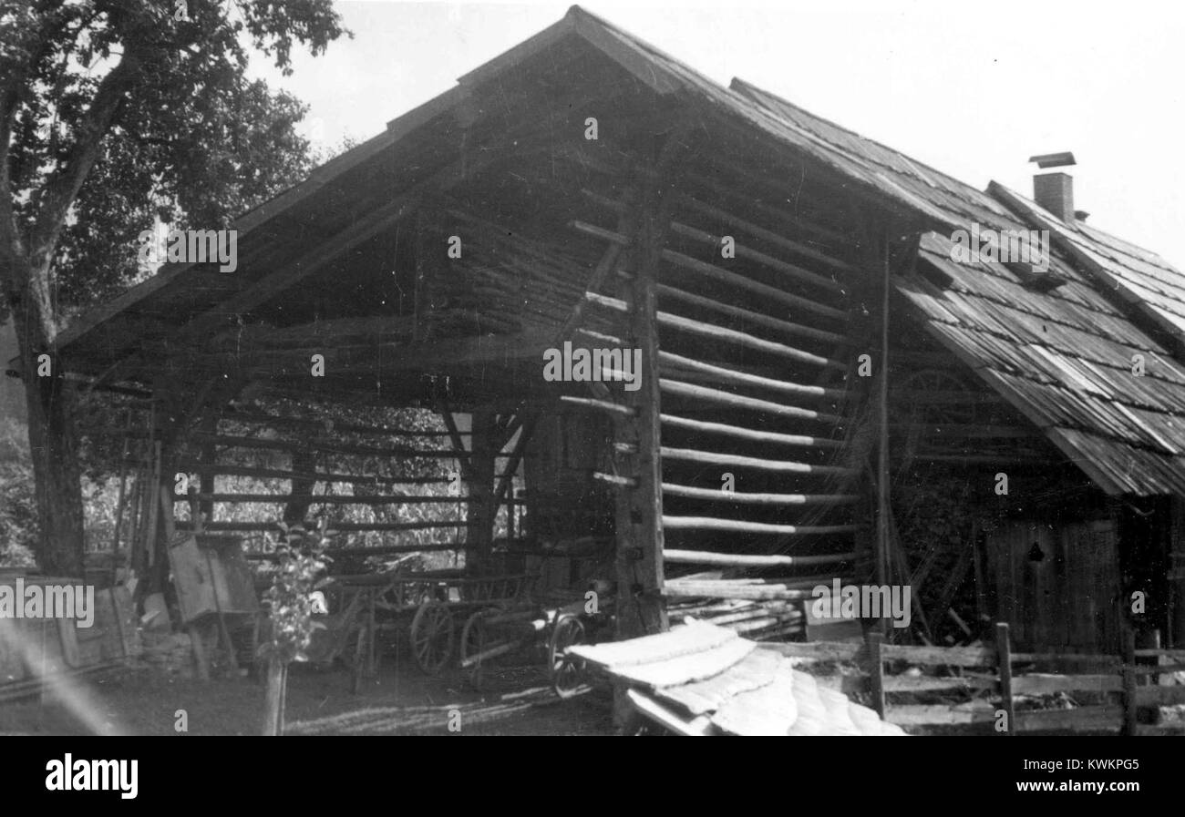 This photograph shows a 'Stog' (hayrack) in front of a barn in Limarce ...