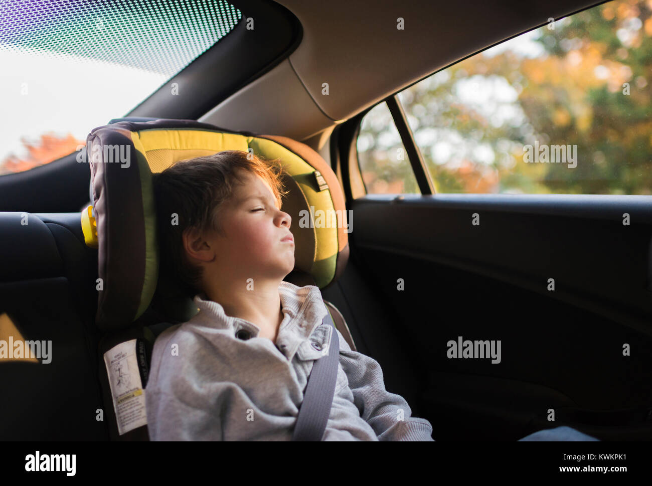 Tired boy sleeping in car Stock Photo - Alamy