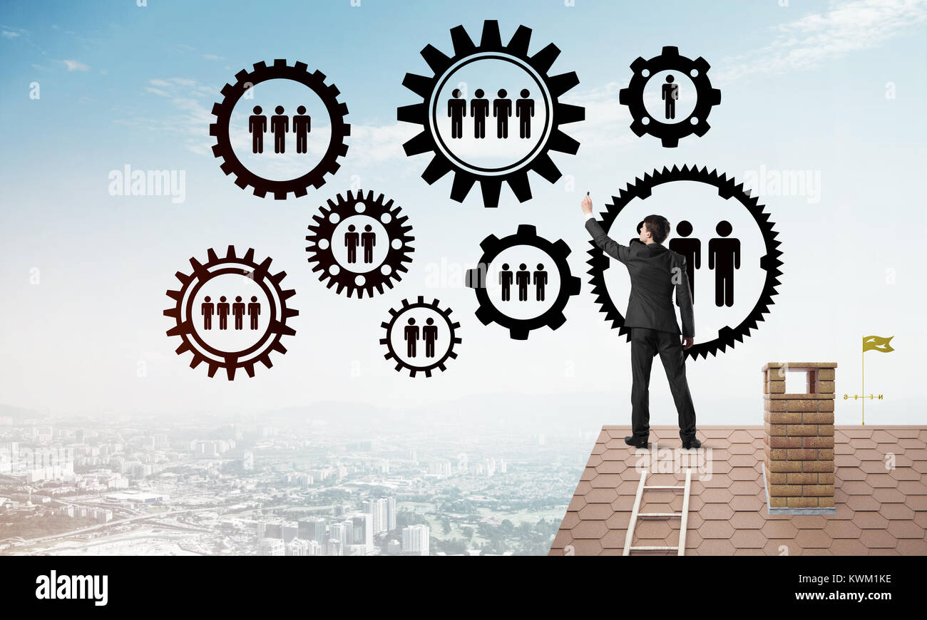 Businessman on house roof presenting teamwork and connection concept ...