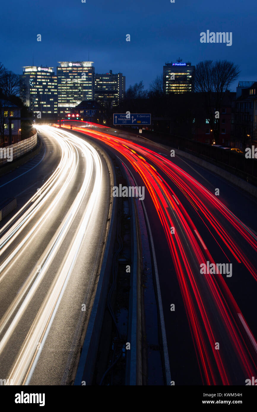 Light trails on Autobahn A40 motorway with the Essen skyline at the ...
