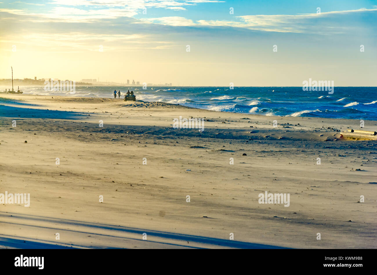 Buggy on the beach at the sunset with people around Stock Photo - Alamy