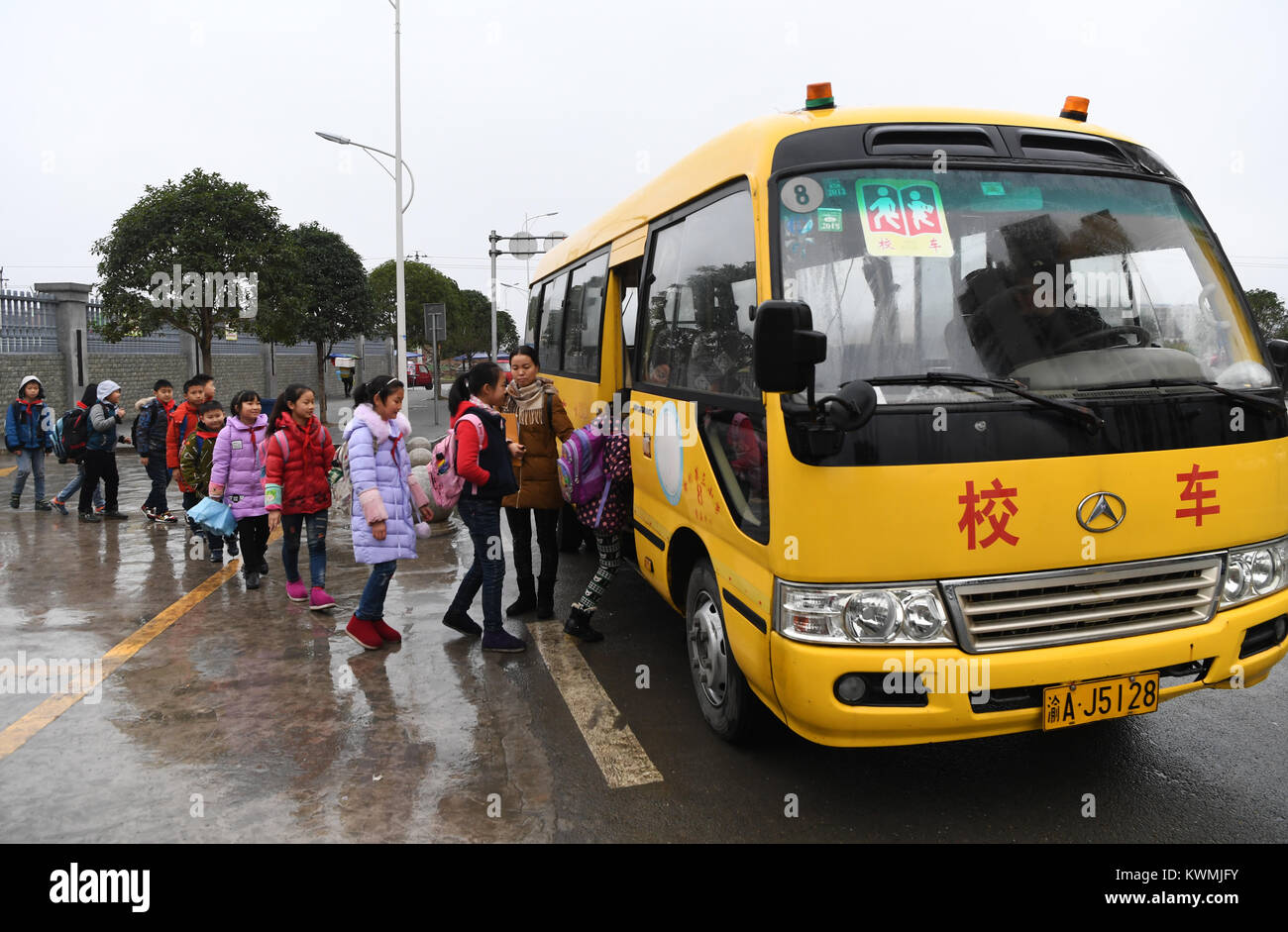 Nanchuan, China. 4th Jan, 2018. Pupils get on a school bus after school ...
