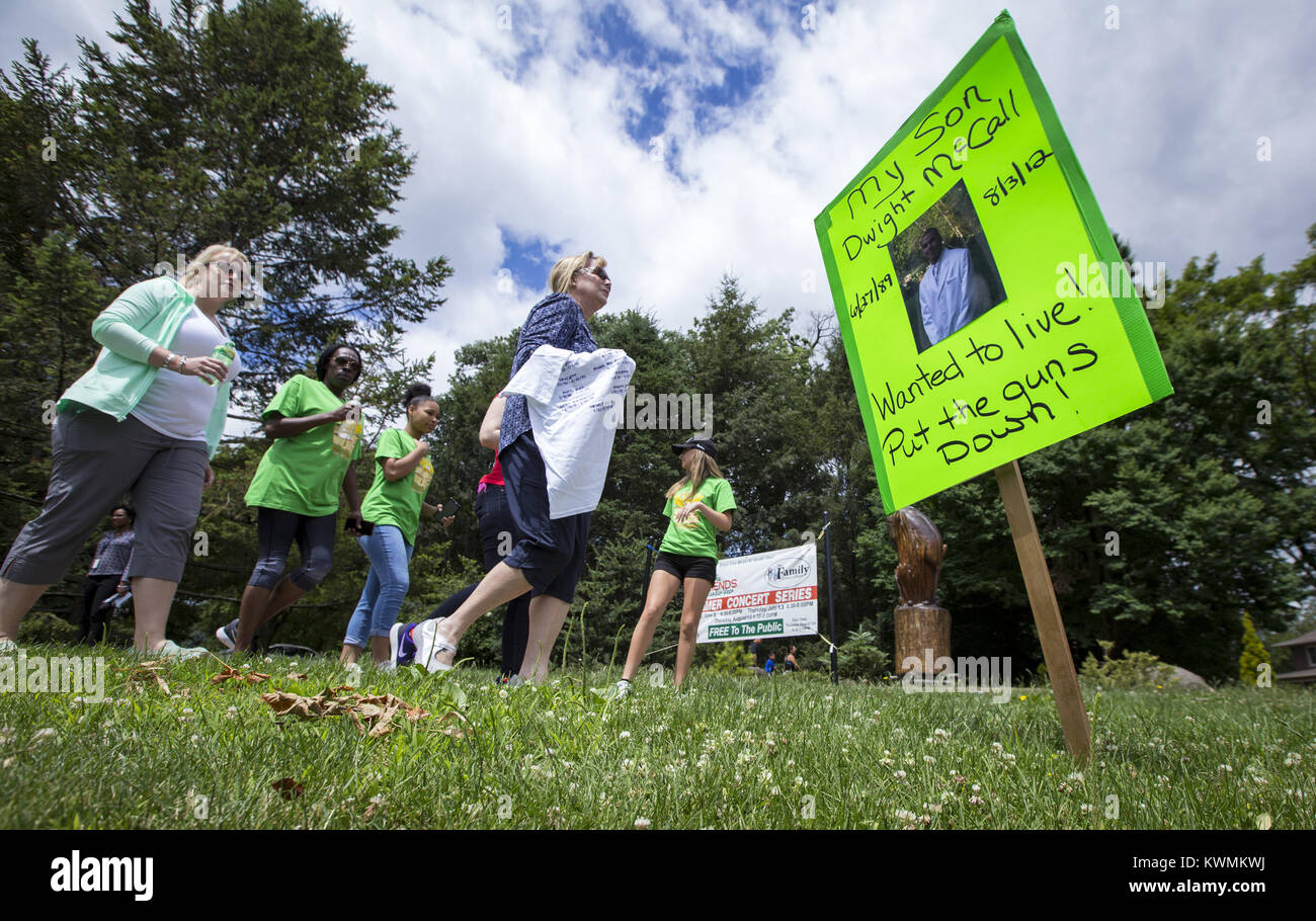 Davenport, Iowa, USA. 25th June, 2017. Marchers pass signs with ...