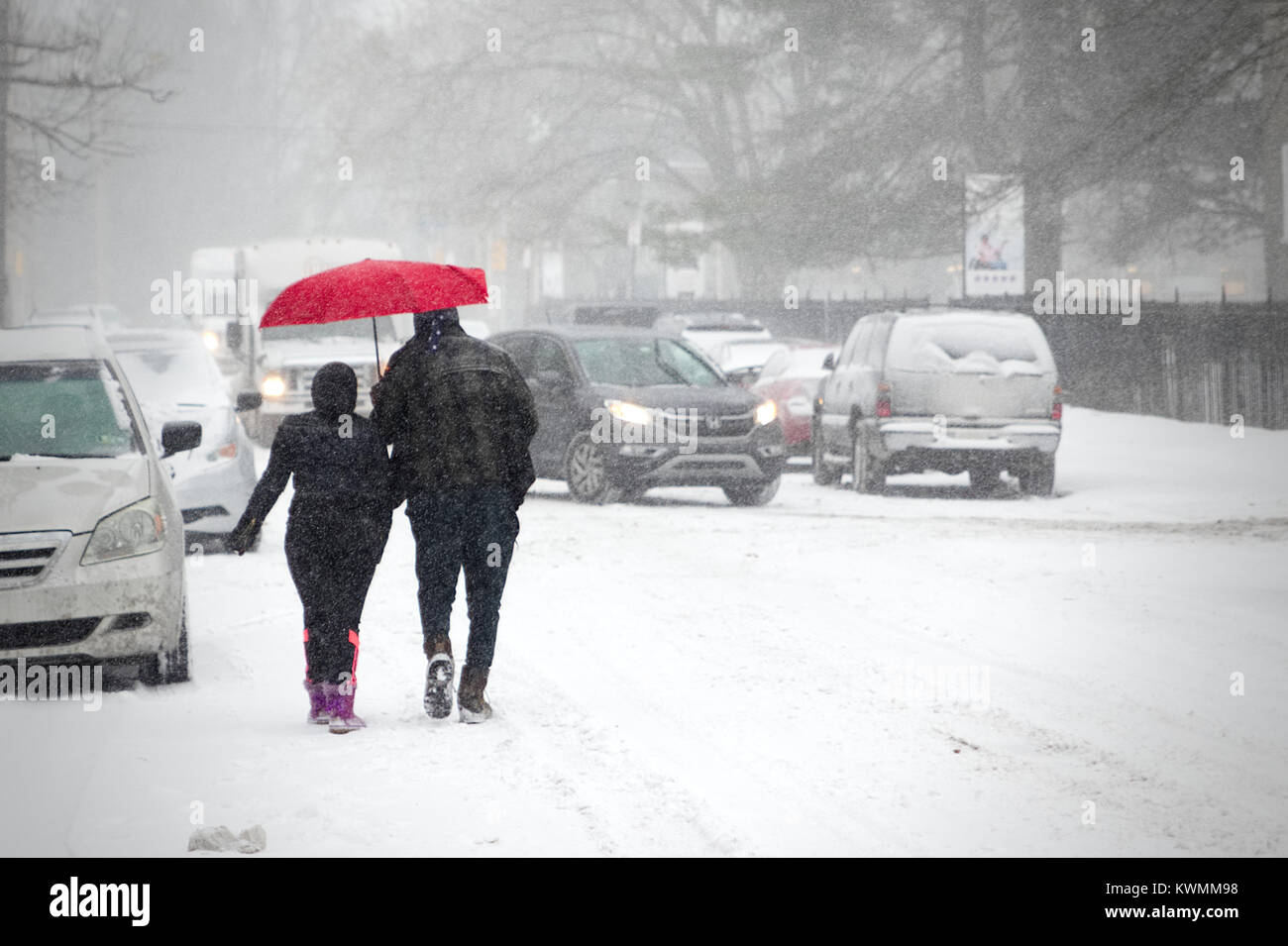 Philadelphia, PA, USA - January 4, 2018: A couple with a red umbrella ...