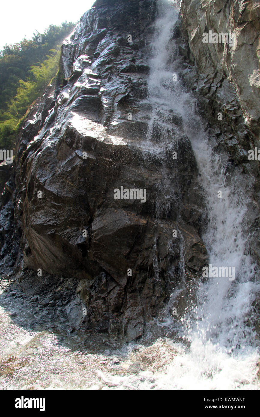 Big rock and small waterfall in Nepal Stock Photo - Alamy