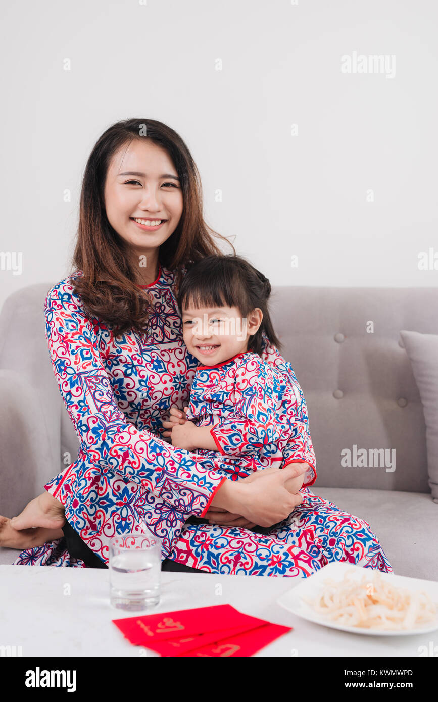 Vietnamese mother and daughter celebrate new year at home. Tet Holiday ...