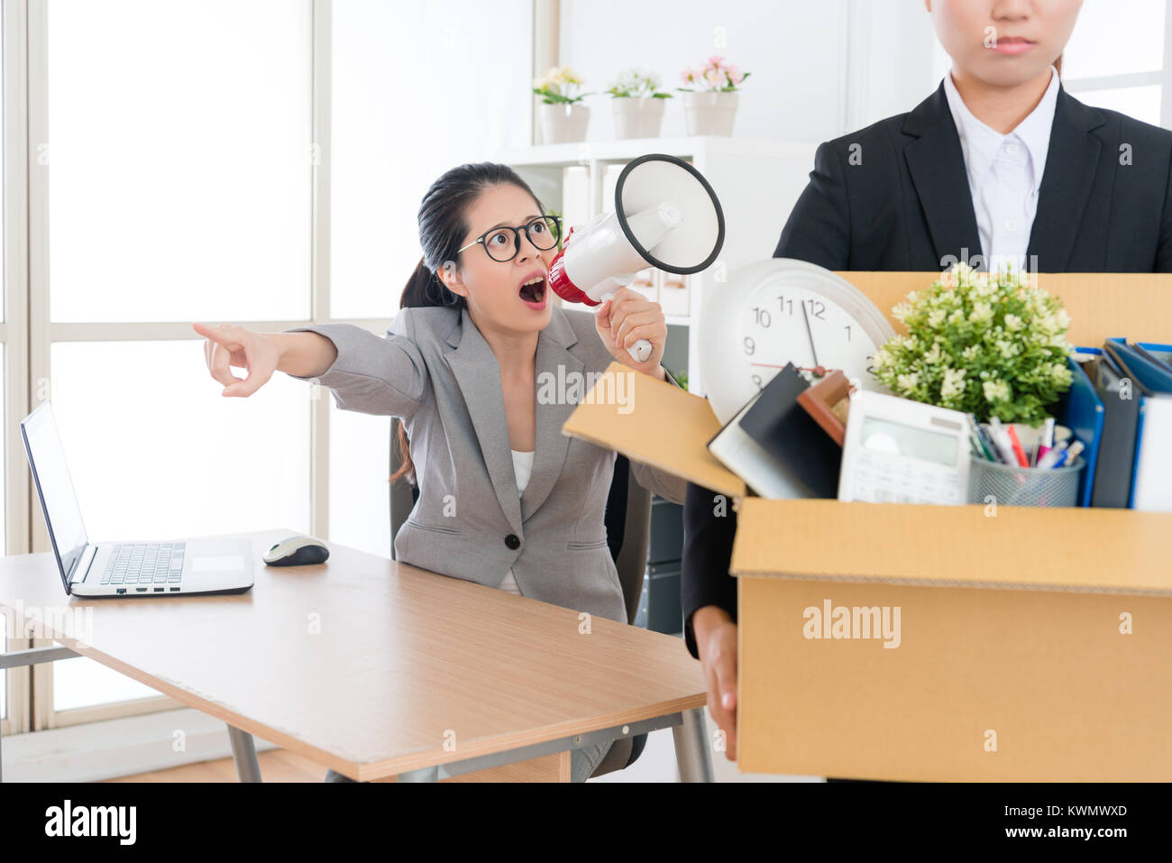 angry young business woman manager using megaphone shouting blame to ...