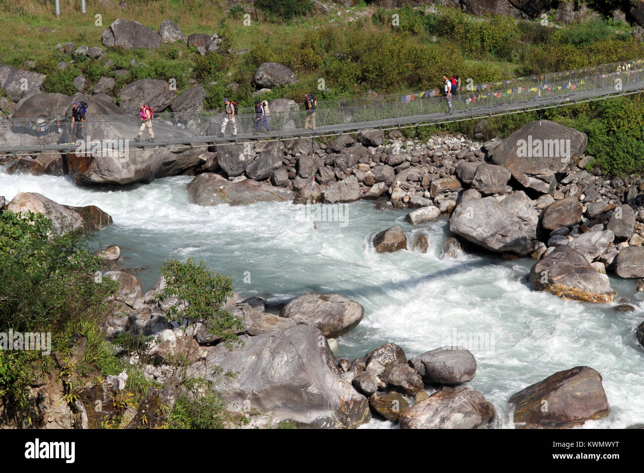 Tourists on the suspension bridge on the Annapurna trail in Nepal Stock ...