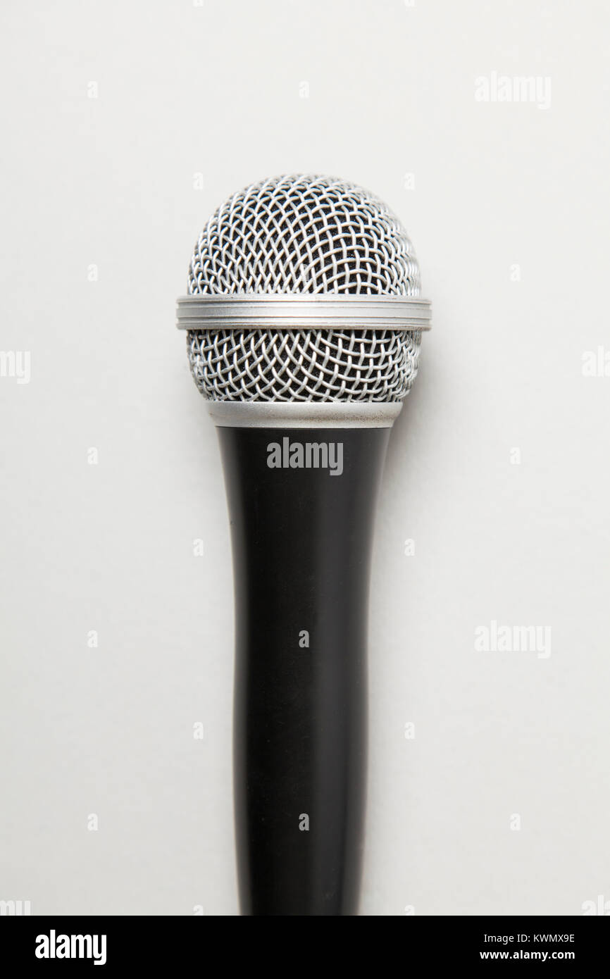 microphone on a plain grey background Stock Photo - Alamy
