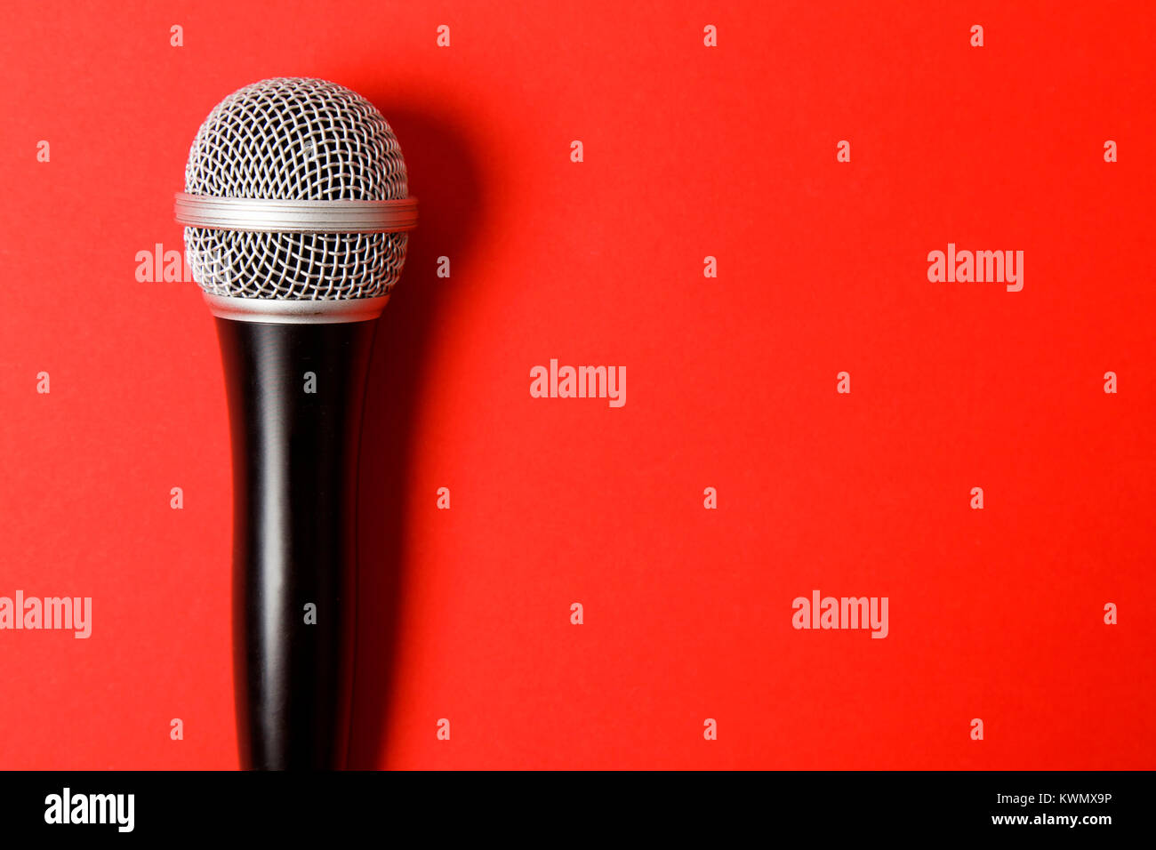 microphone on a bright red background Stock Photo - Alamy