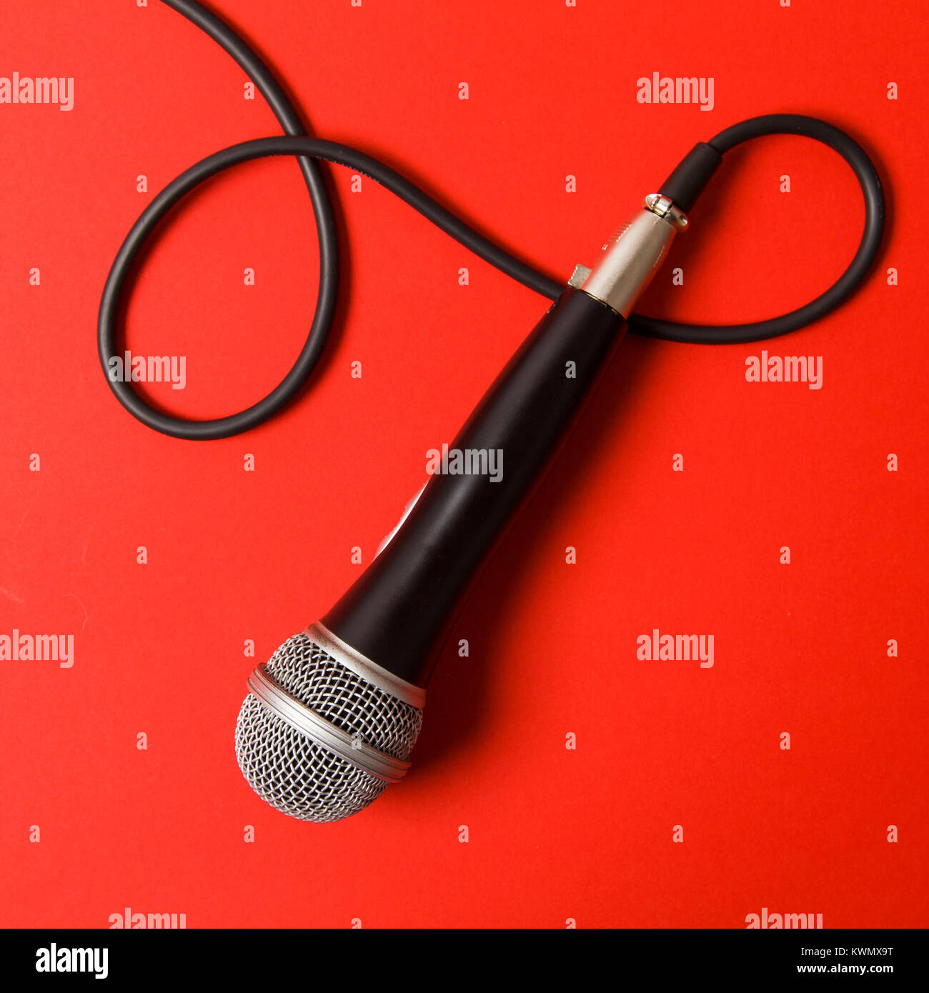 microphone and lead on a bright red background Stock Photo - Alamy