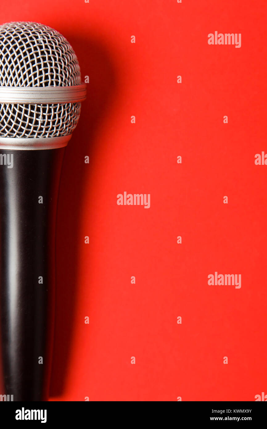 microphone on a bright red background Stock Photo - Alamy