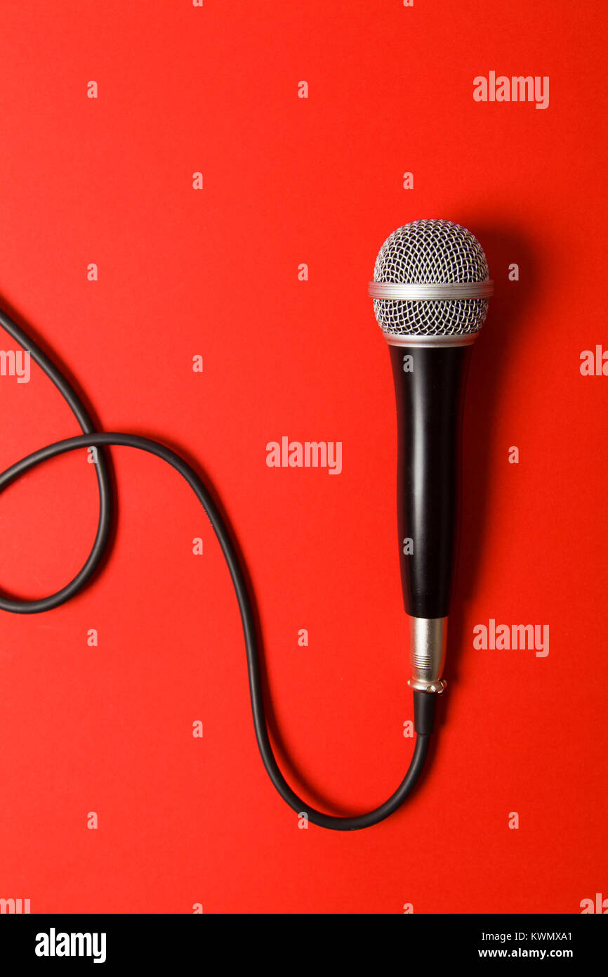 microphone and lead on a bright red background Stock Photo - Alamy