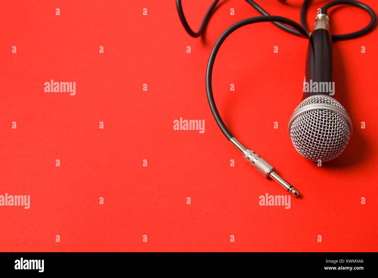 microphone and lead on a bright red background Stock Photo - Alamy