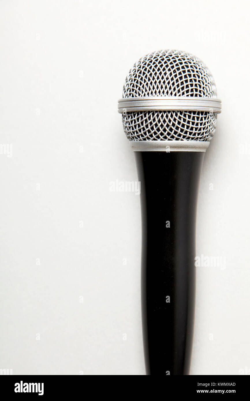 microphone on a plain grey background Stock Photo - Alamy