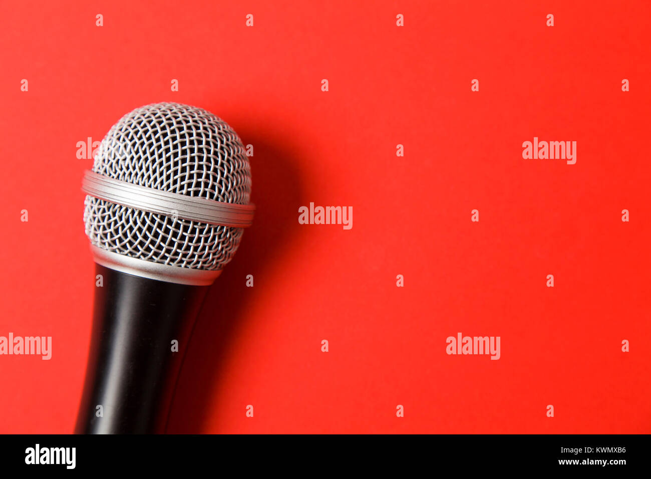 microphone on a bright red background Stock Photo - Alamy