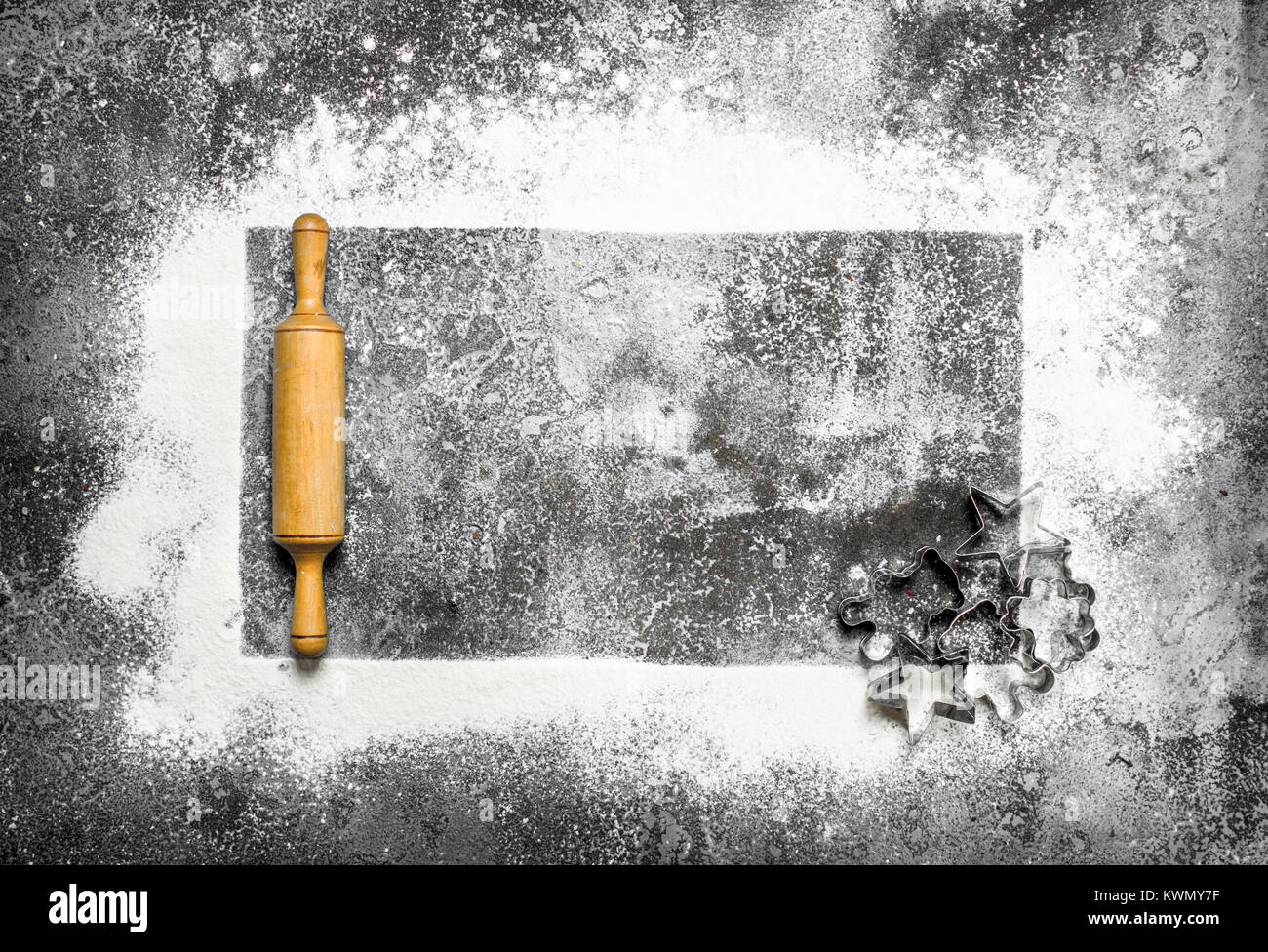 Baking background. A flour frame and dough tools. On a rustic ...