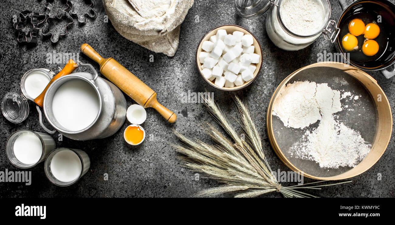 Baking background. Milk, flour and other ingredients for the dough. On ...
