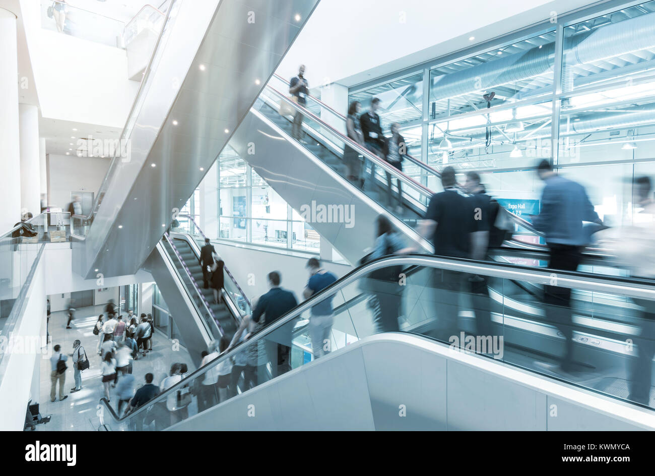 Blurred business people on a escalator Stock Photo - Alamy