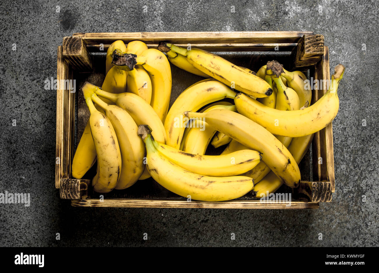 Fresh bananas in an old box. On a rustic background Stock Photo - Alamy