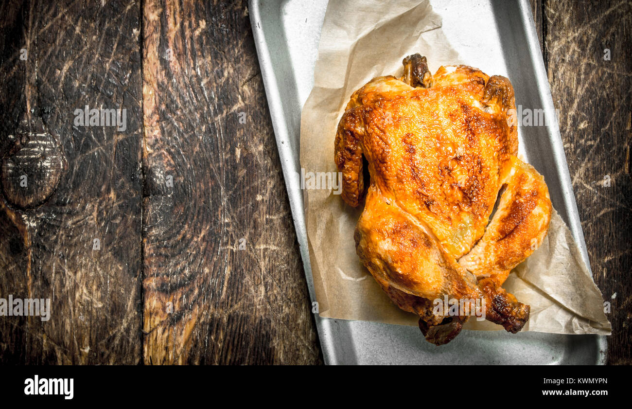 Fried chicken on a tray. On a wooden table Stock Photo - Alamy