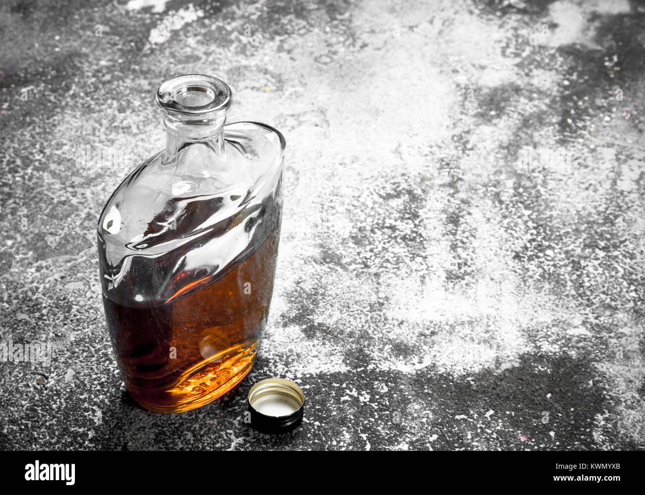 French cognac in bottle. On a rustic background Stock Photo - Alamy