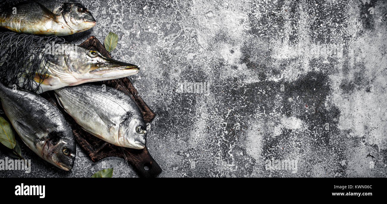 Fresh unprepared fish. On a rustic background Stock Photo - Alamy