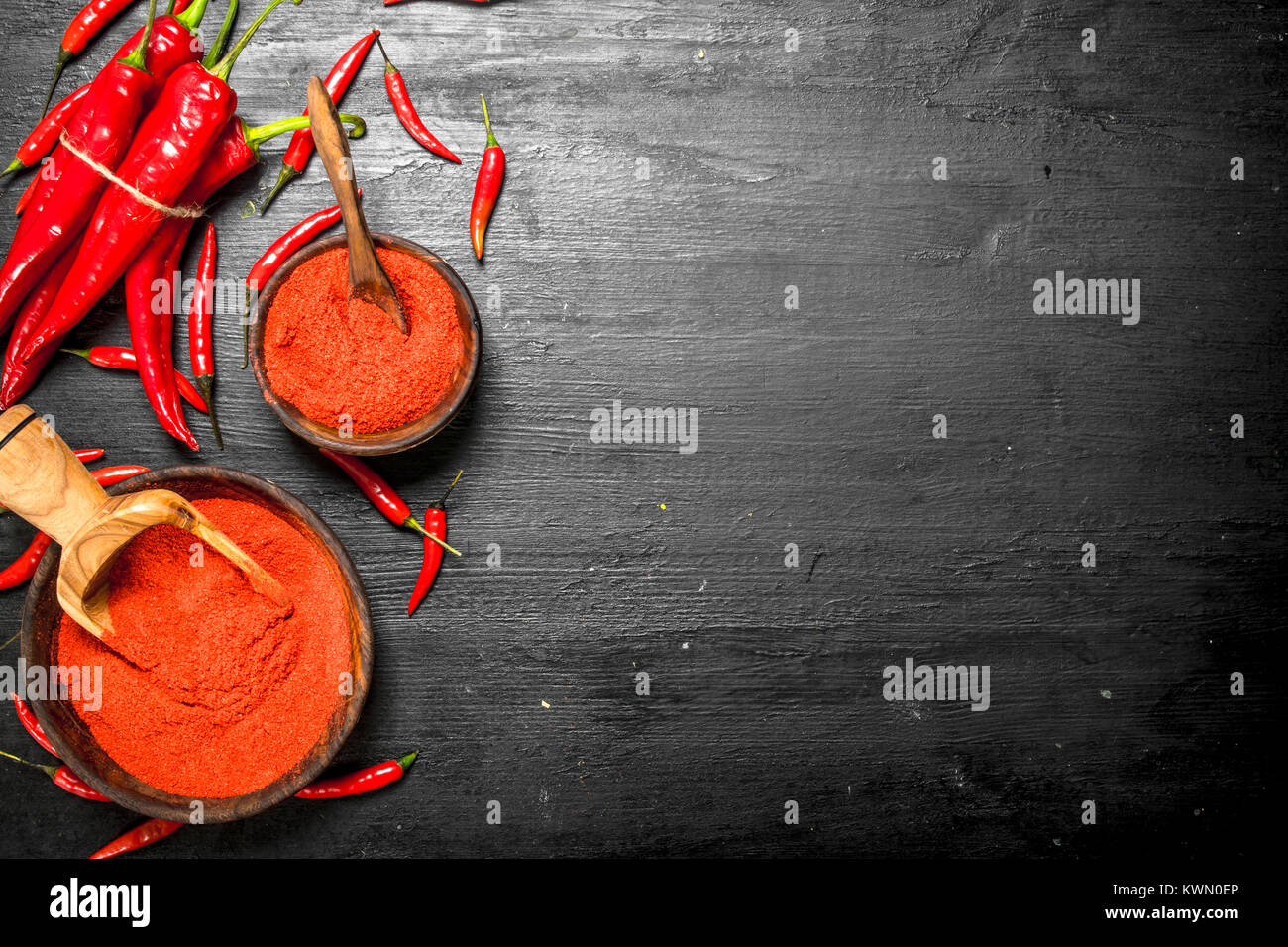 Ground hot peppers in a wooden bowl. On the black chalkboard Stock ...