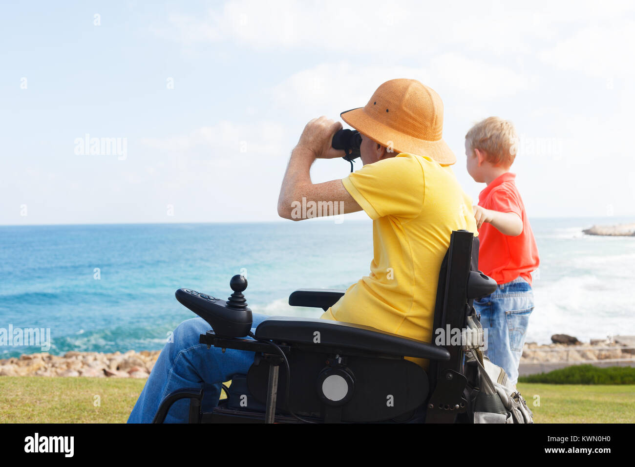 Disabled father and son play with binocular Stock Photo - Alamy