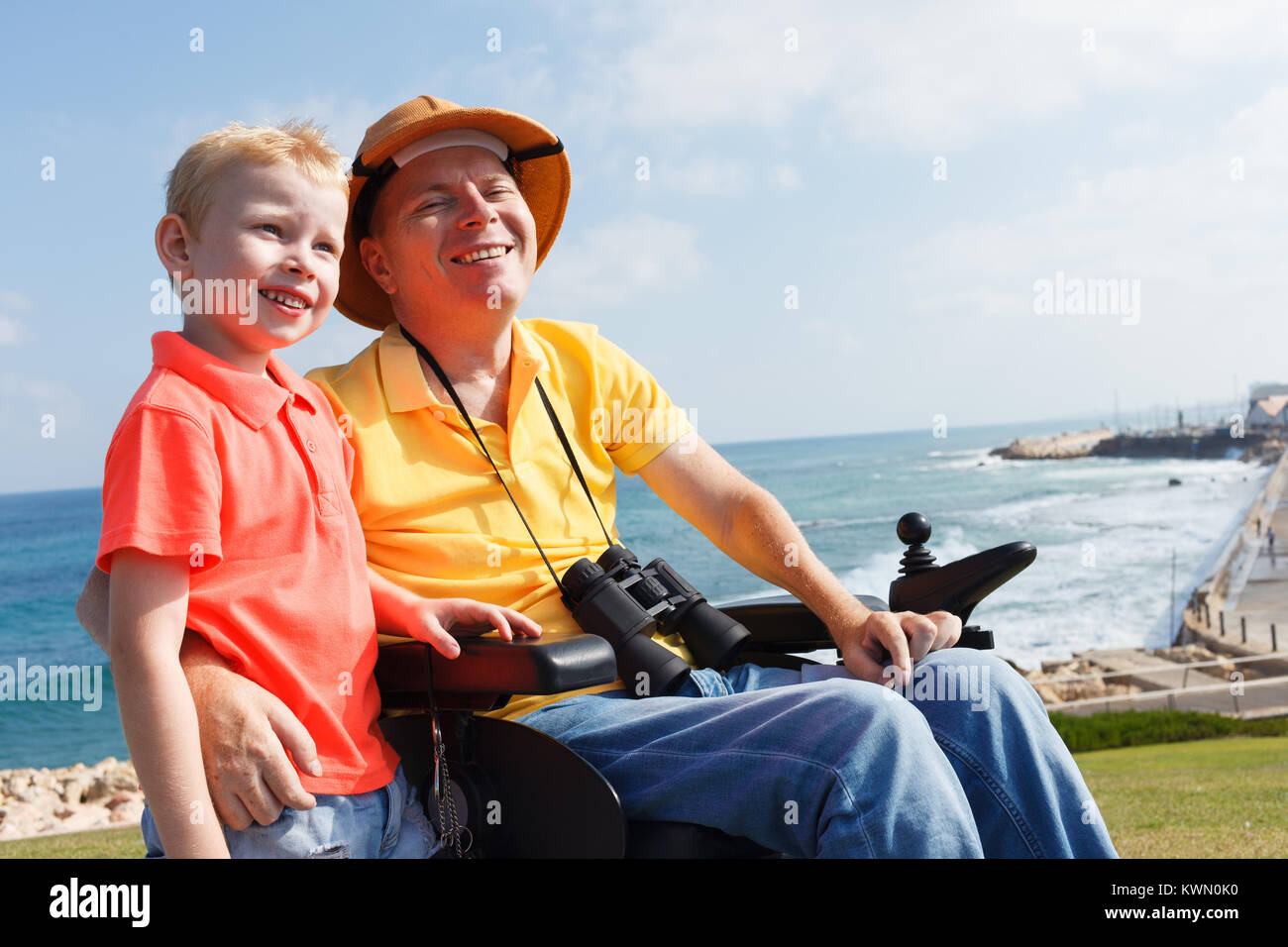 Disabled father and son play with binocular Stock Photo - Alamy