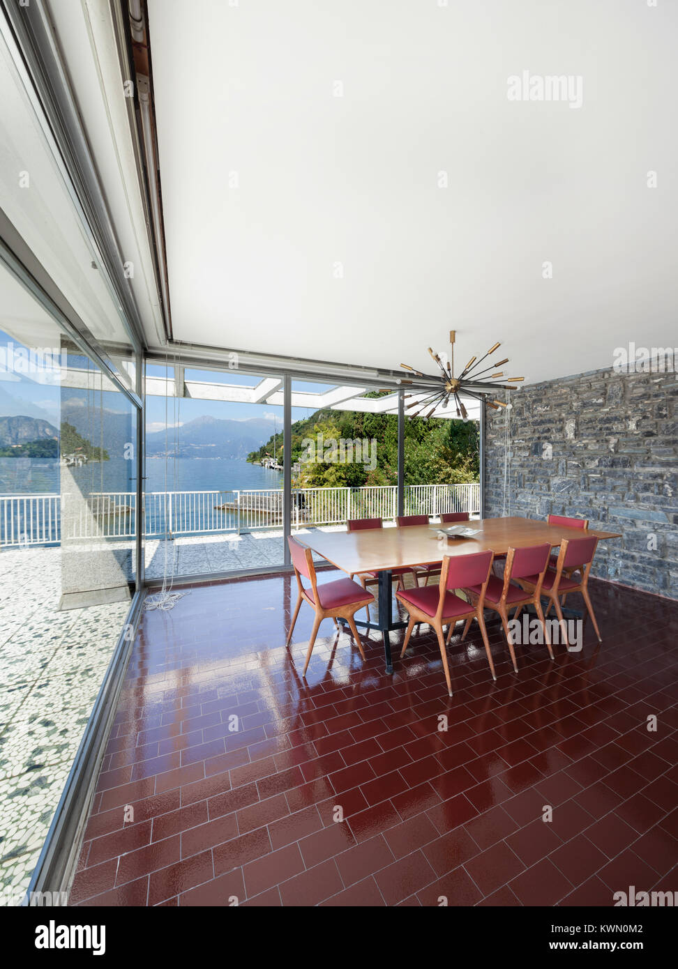 Old dining room of an apartment, red floor and stone wall Stock Photo ...