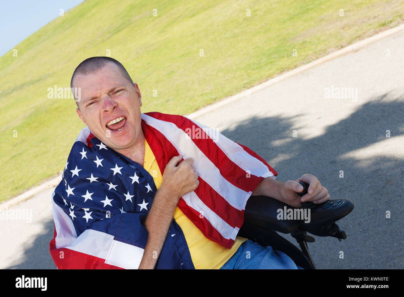 Disabled man singing in wheelchair with American flag Stock Photo - Alamy