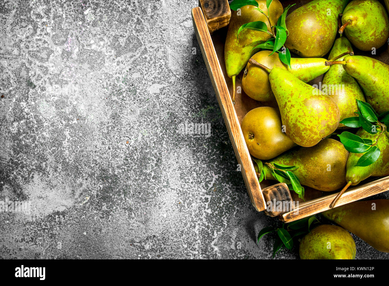 Fresh pears in a box. On a rustic background Stock Photo - Alamy