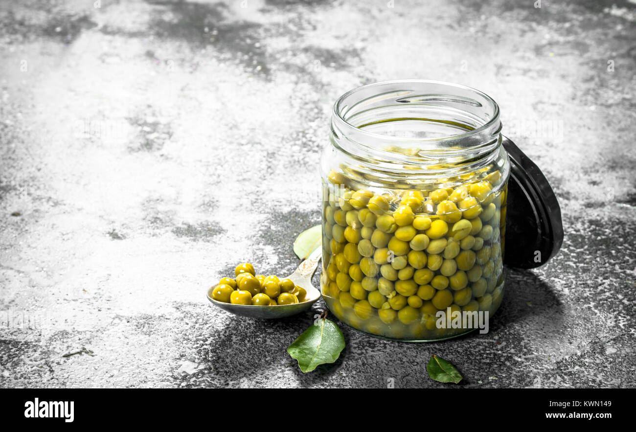 Marinated green peas in glass jar. On a rustic background Stock Photo ...