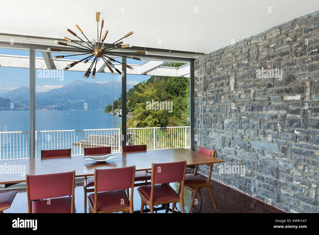 Old dining room of an apartment, red floor and stone wall Stock Photo ...