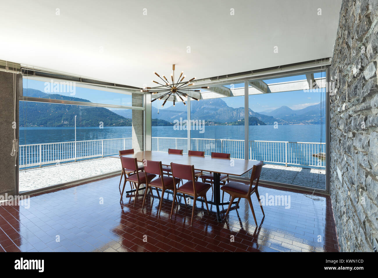 Old dining room of an apartment, red floor and stone wall Stock Photo ...