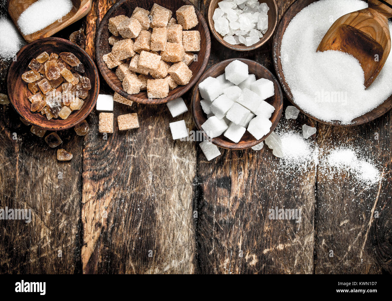 Different types of sugar in bowls. On a wooden background Stock Photo ...