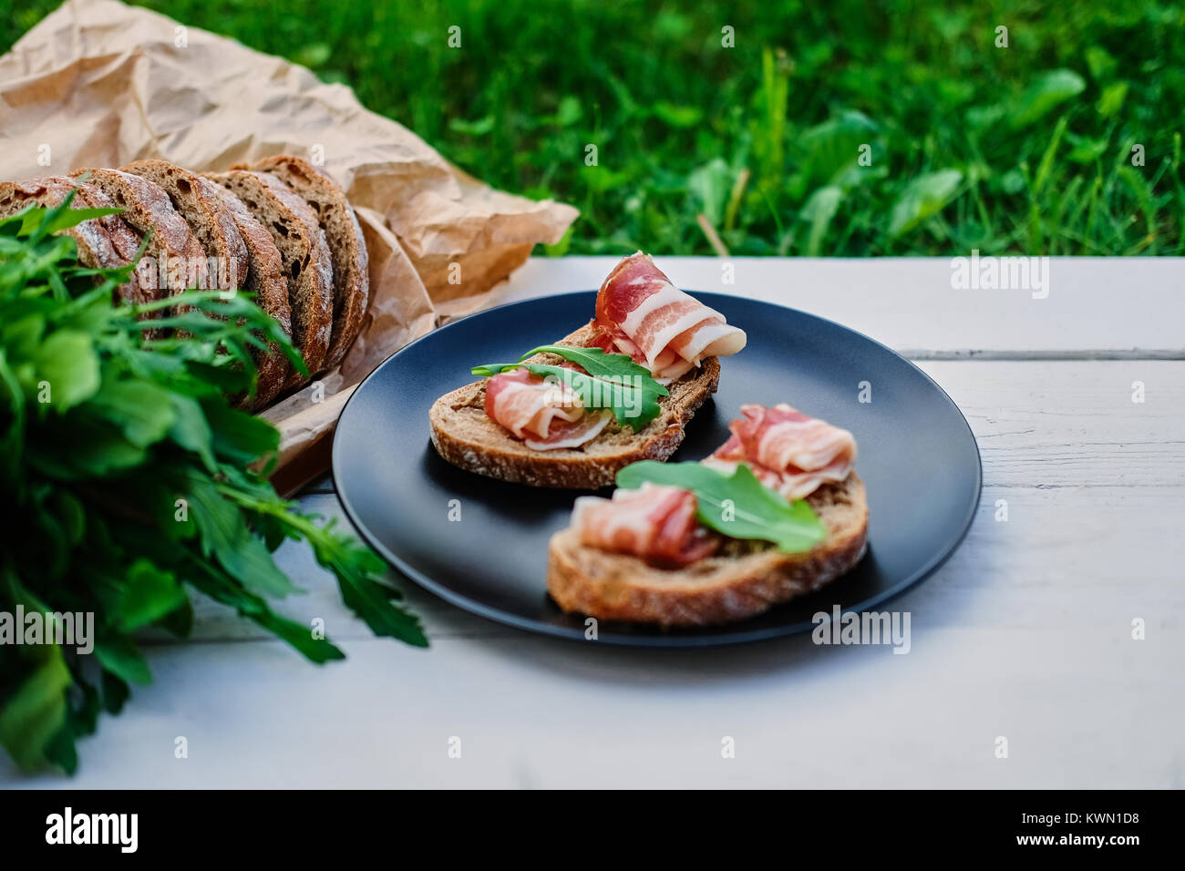 Bread with ham and herbs on a plate Stock Photo - Alamy