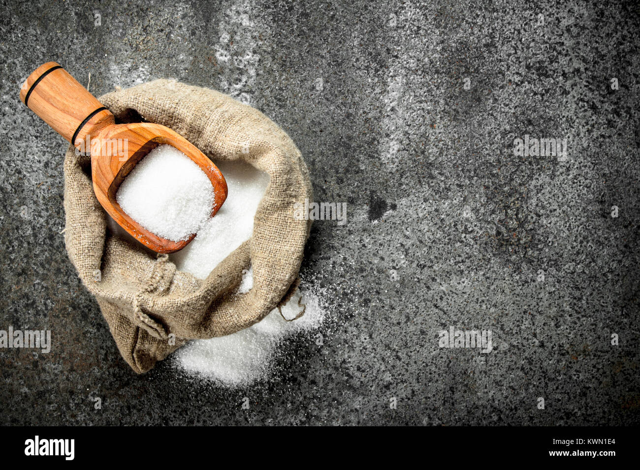 Sugar in an old sack with a scoop. On a rustic background Stock Photo ...