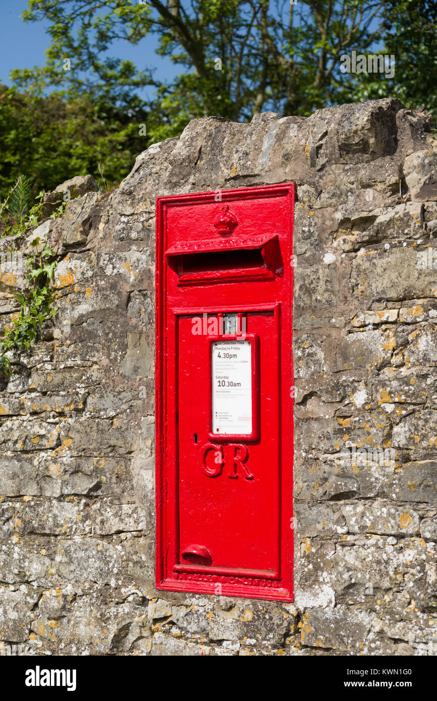 Red post Box built into the stone wall, Combrook, Warwickshire, England ...